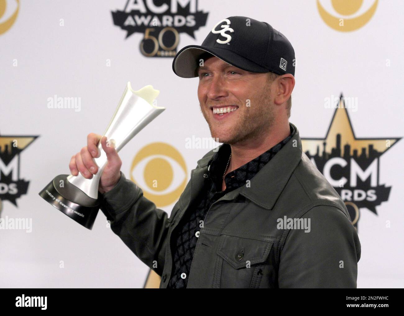 Cole Swindell poses in the press room with the award for new artist of ...