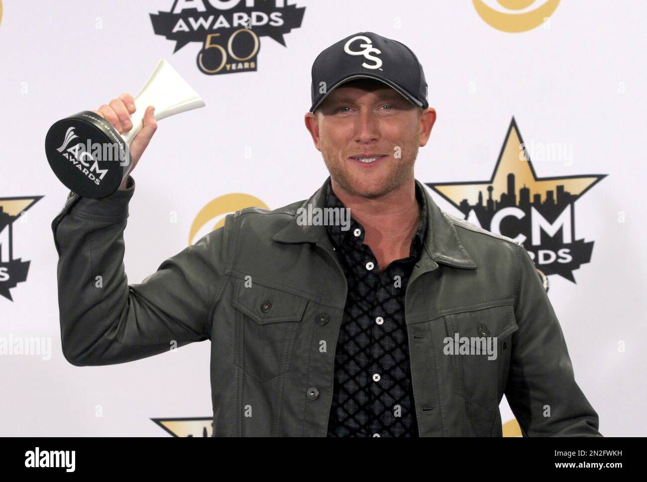 Cole Swindell poses in the press room with the award for new artist of ...