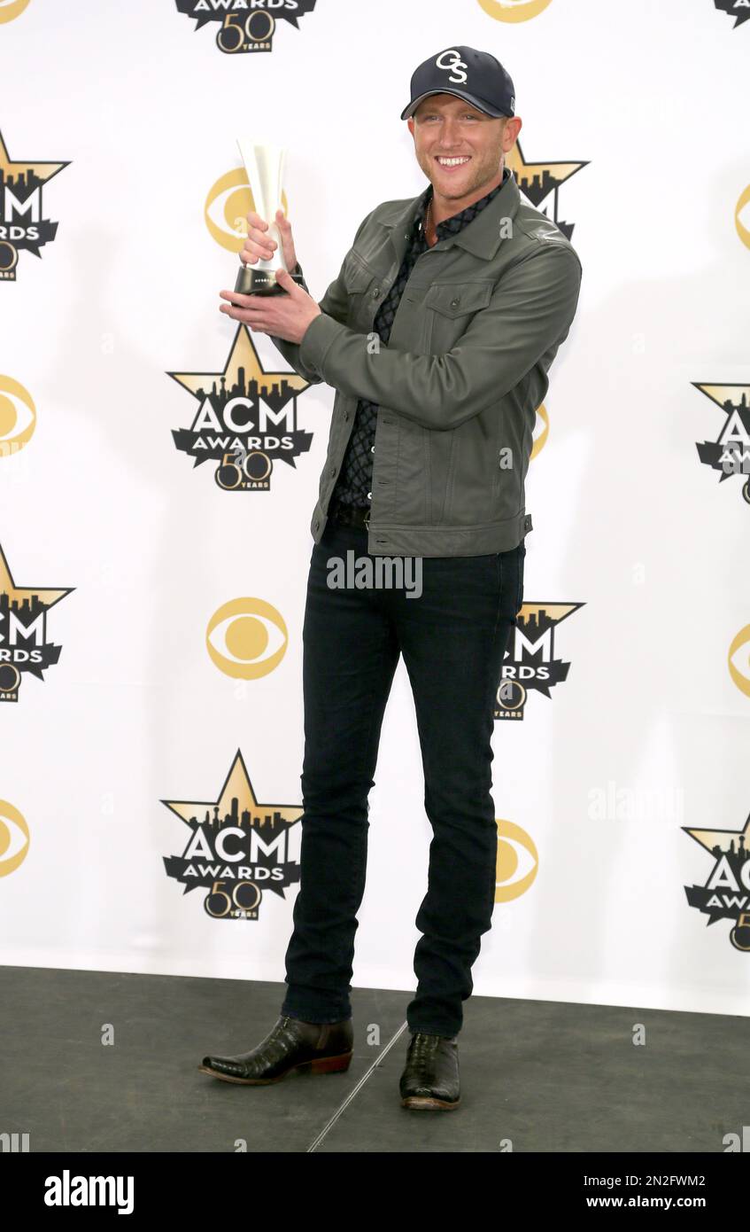 Cole Swindell poses in the press room with the award for new artist of ...