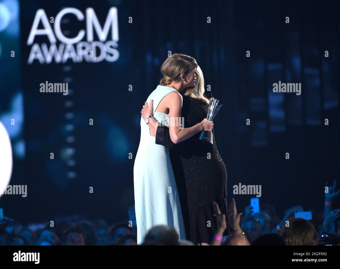 Andrea Finlay, right, presents the milestone award to Taylor Swift at ...