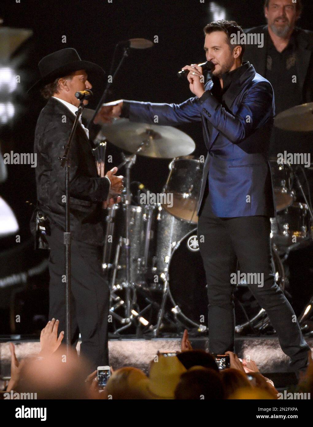 Luke Bryan, right, presents the milestone award to George Strait at the ...