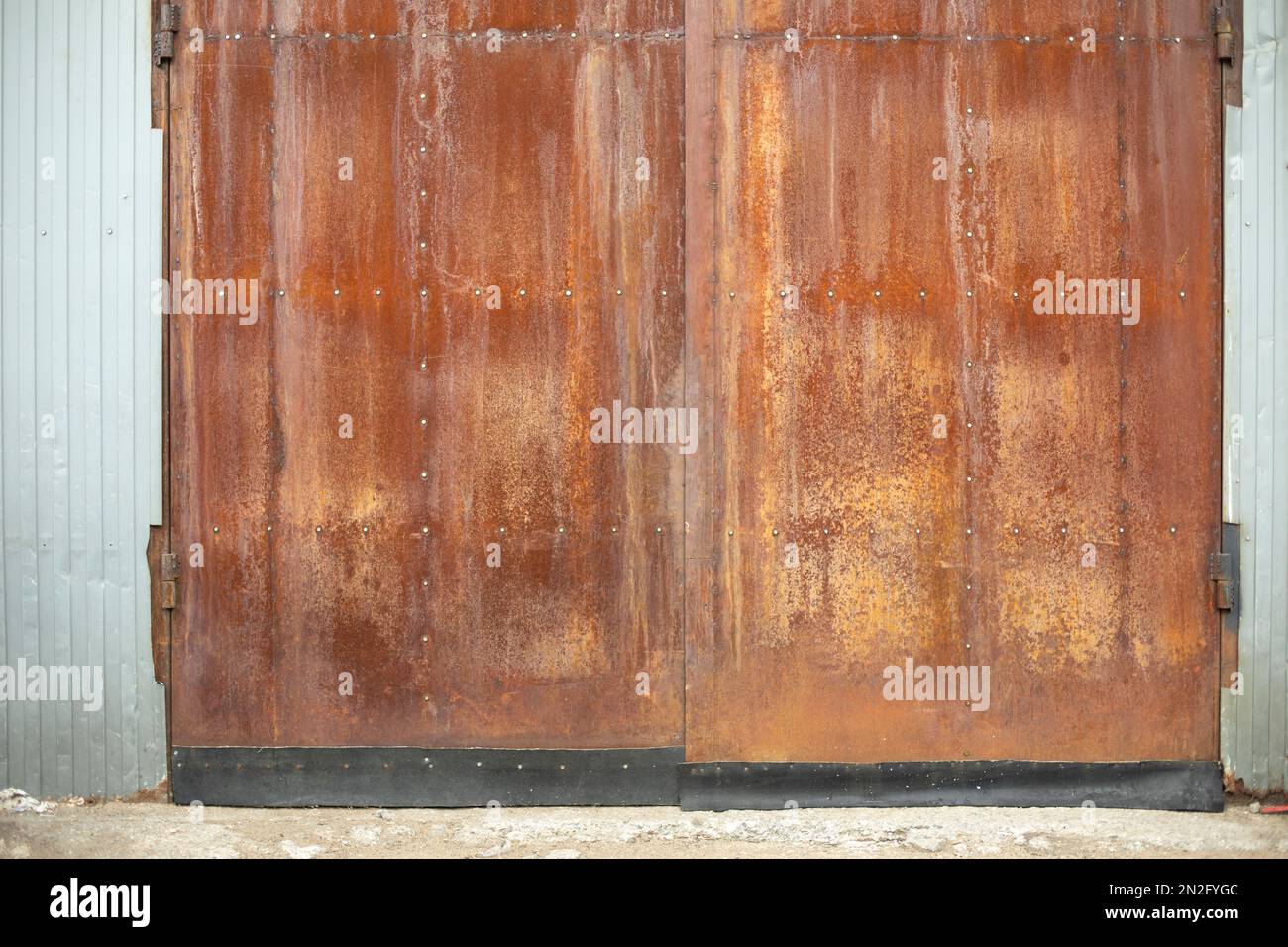 Rusty gate to warehouse. Large garage door. Details of industrial ...