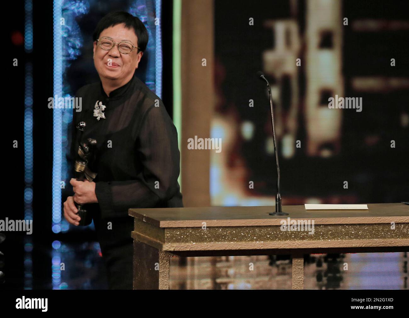 Hong Kong director Ann Hui reacts after winning the Best Director Award ...