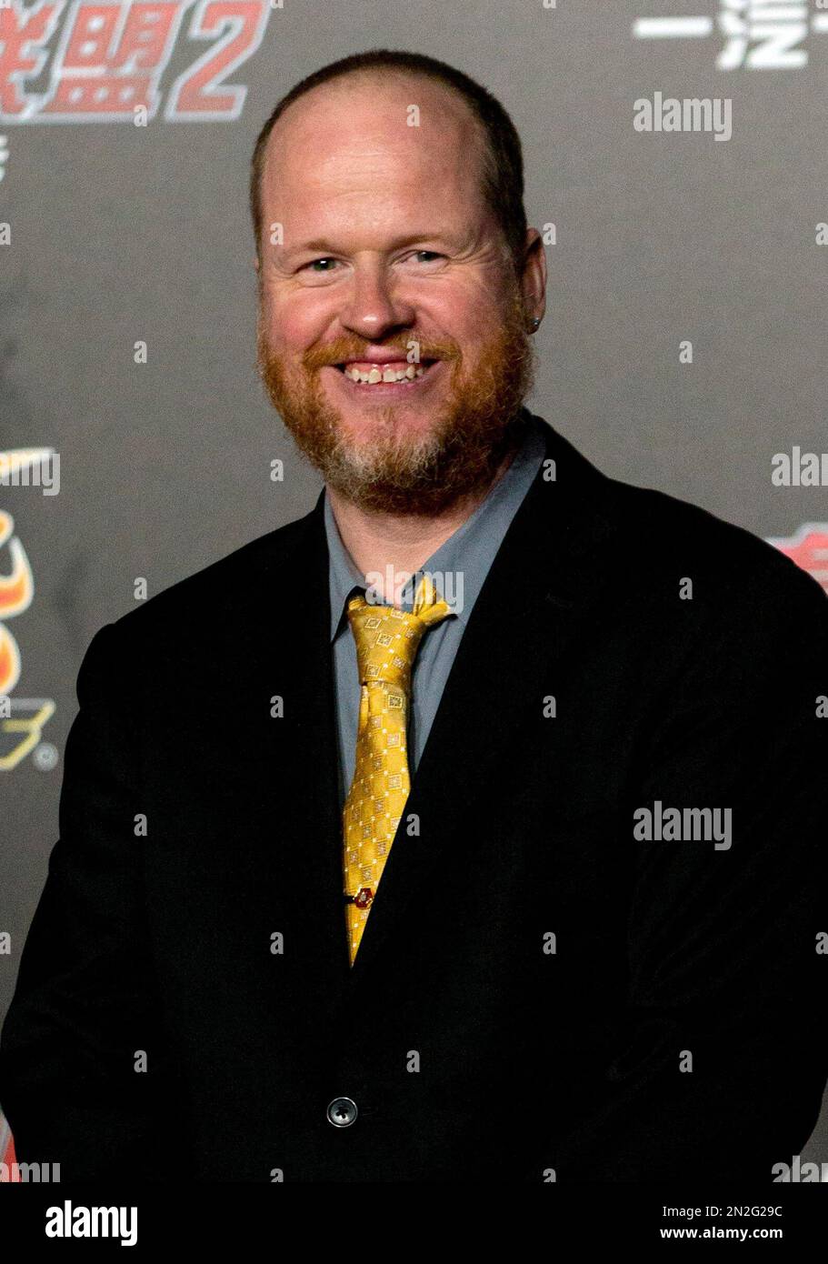 Director Joss Whedon poses for photos at a red carpet event for his ...