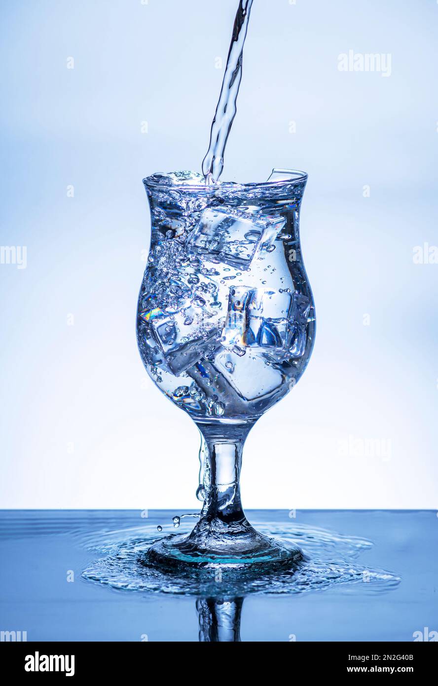 The image of pouring drinking water, into a broken glass, that makes ...