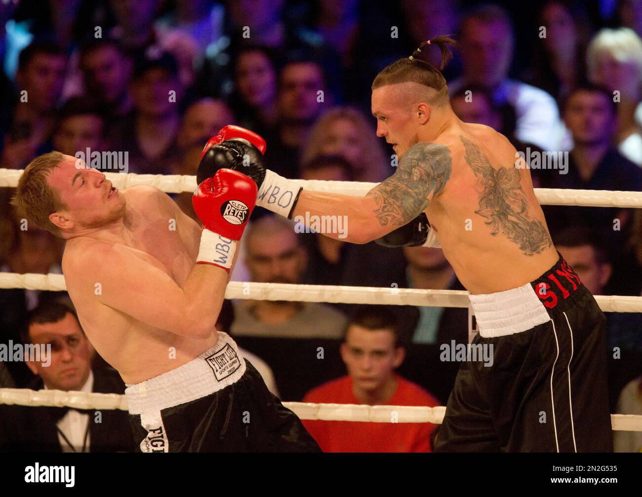 Ukrainian boxing Olympic champion Oleksandr Usyk, right, throws a punch ...