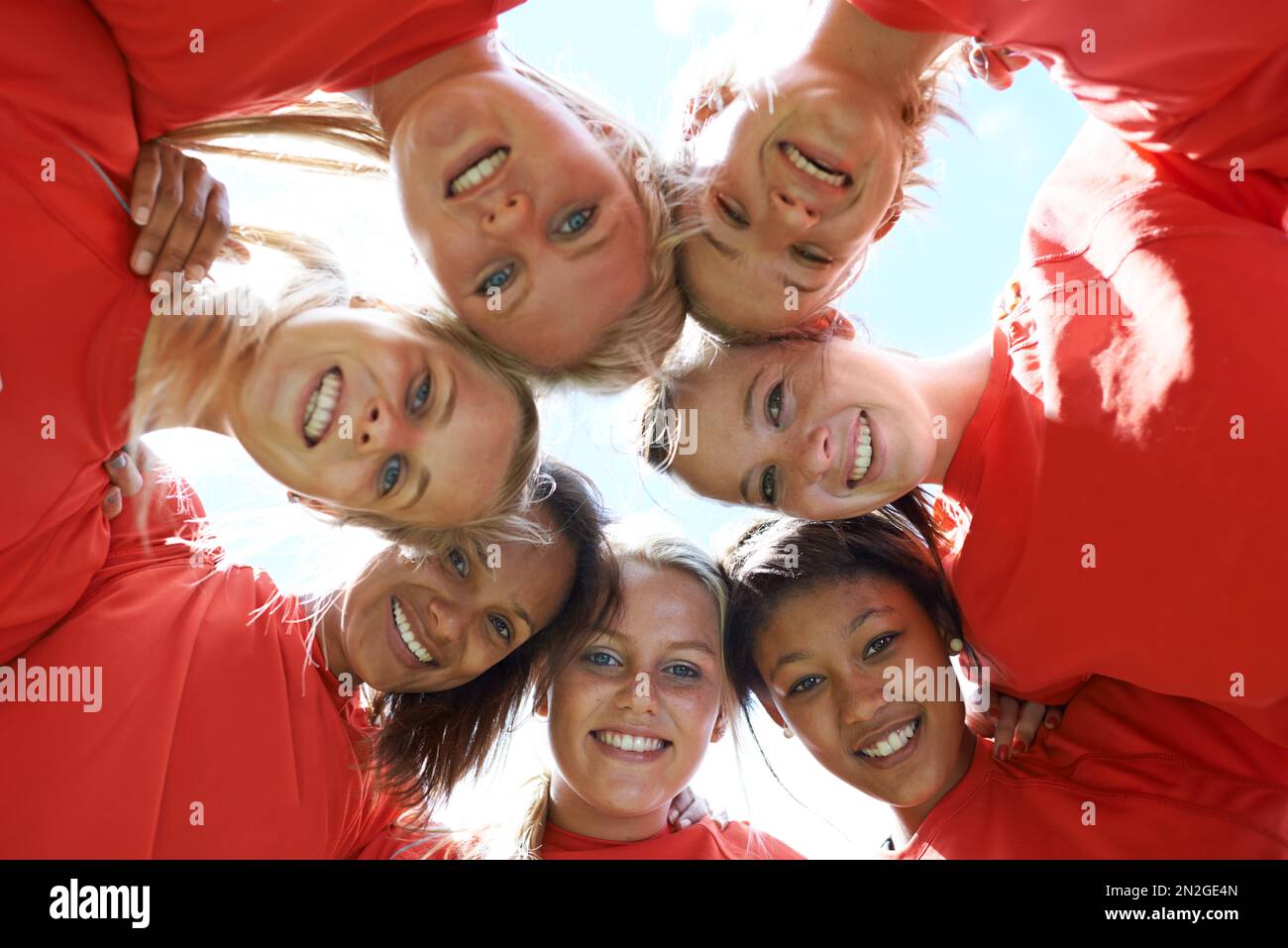 NoI in team. Low-angle portrait of an all-girls soccer team standing in ...