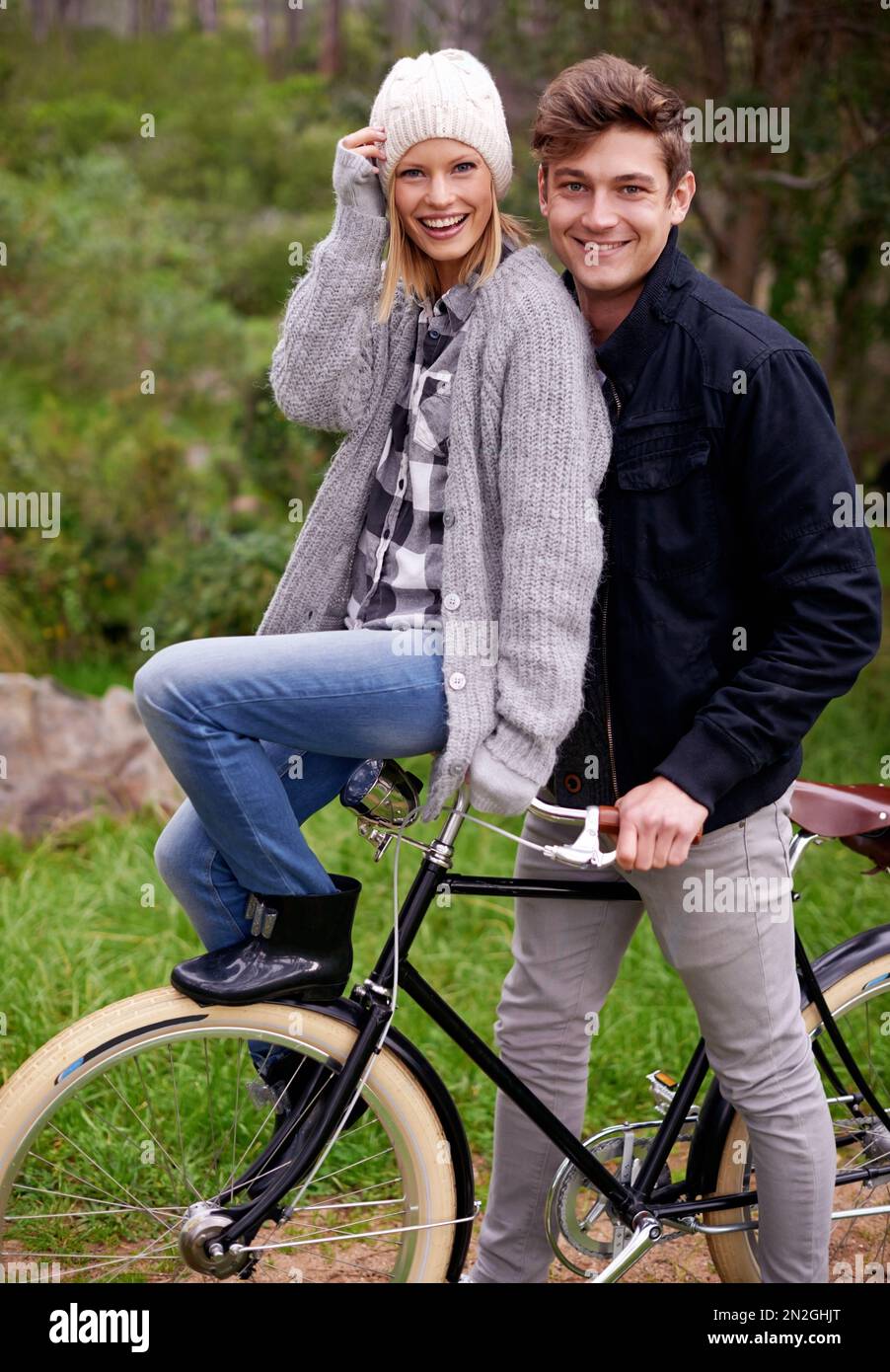 Romantic ride in the country. A young couple enjoying a bike ride ...