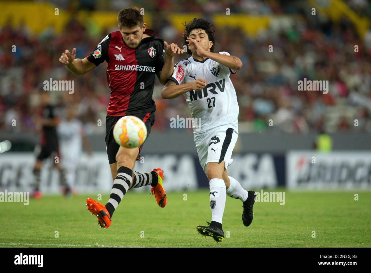 Walter Kannemann, left, of Mexico's Atlas fights for the ball with Luan ...
