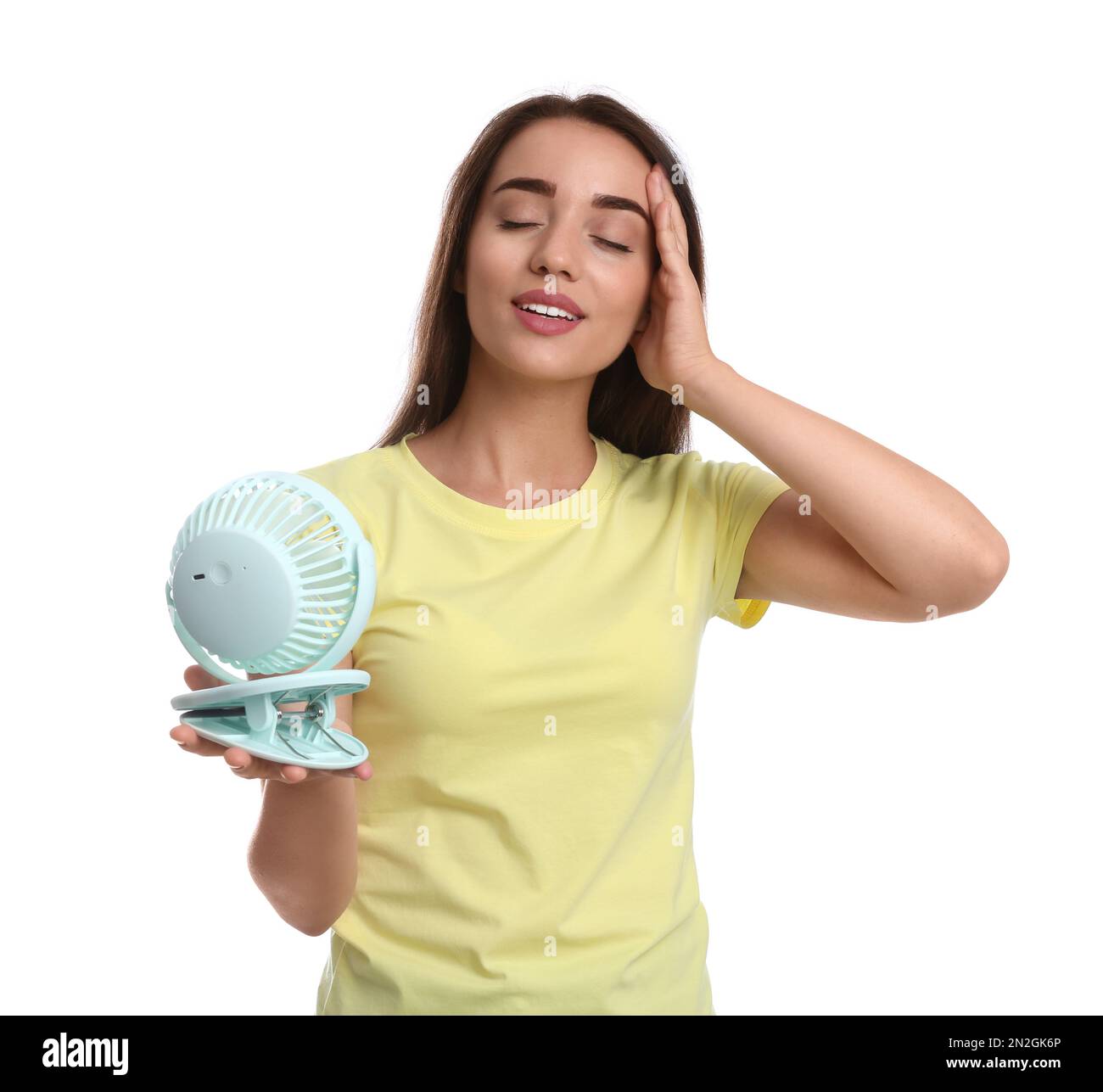 Woman enjoying air flow from portable fan on white background. Summer ...