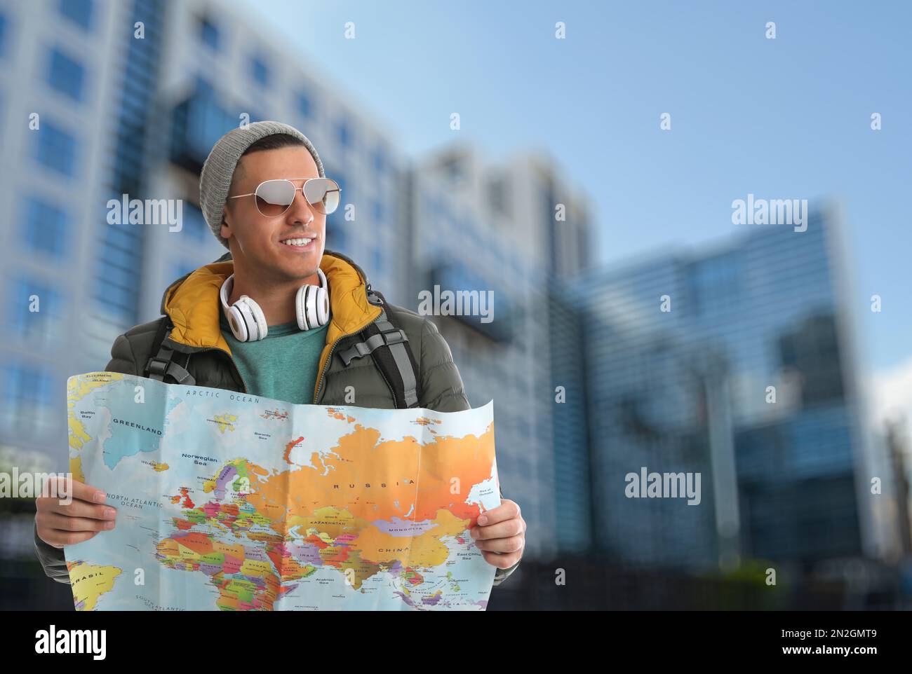 Happy traveler with map in foreign city. Vacation trip Stock Photo - Alamy
