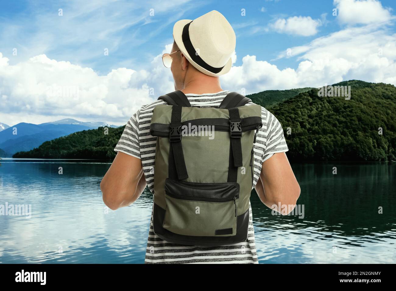 Tourist with travel backpack enjoying mountain landscape during summer ...