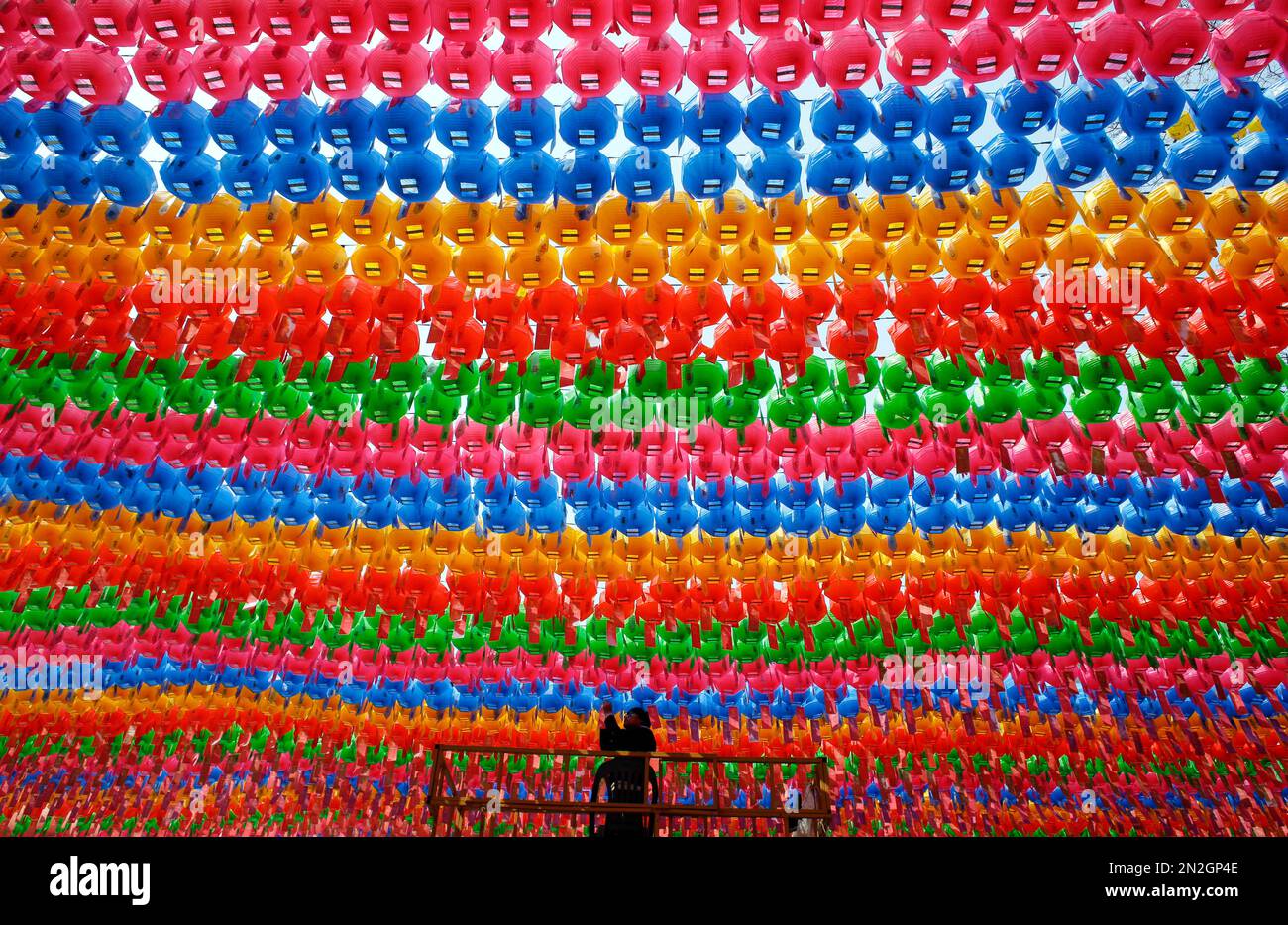 A worker attaches the name tag of a Buddhist who made donation to a ...