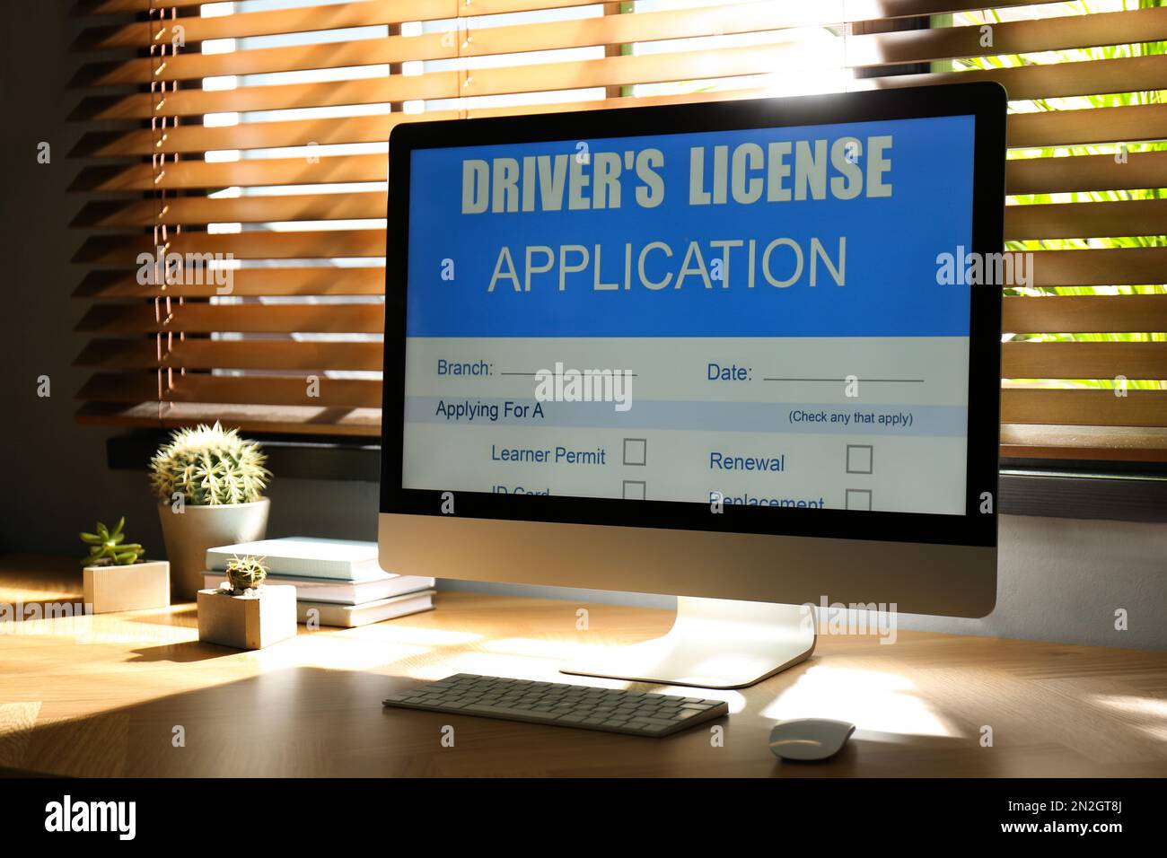 Computer with driver's license application form on table in office Stock Photo - Alamy