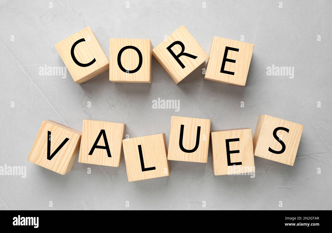 Wooden cubes with phrase CORE VALUES on grey background, flat lay Stock ...