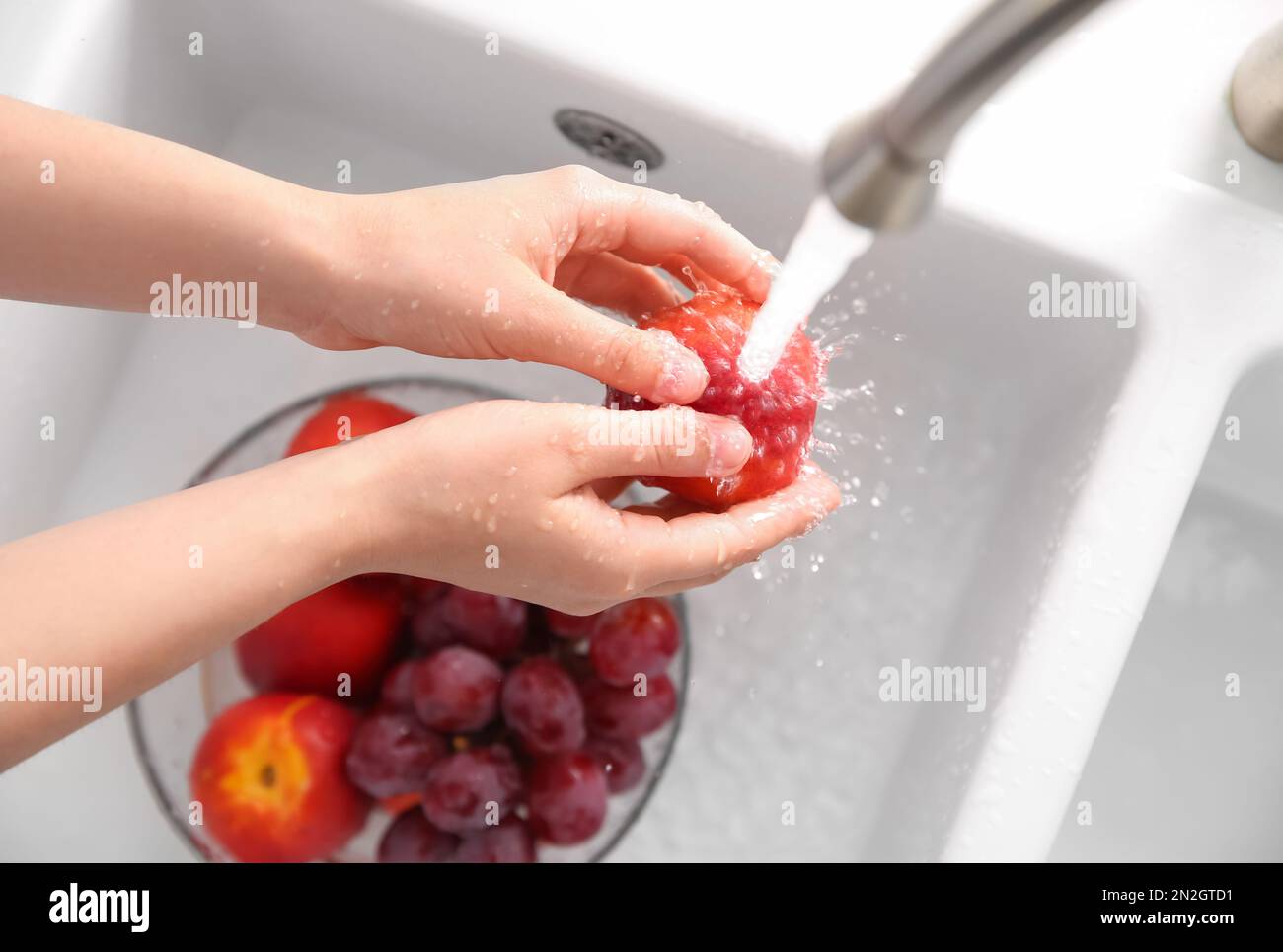 Closeup hands washing fresh fruits hi-res stock photography and images ...