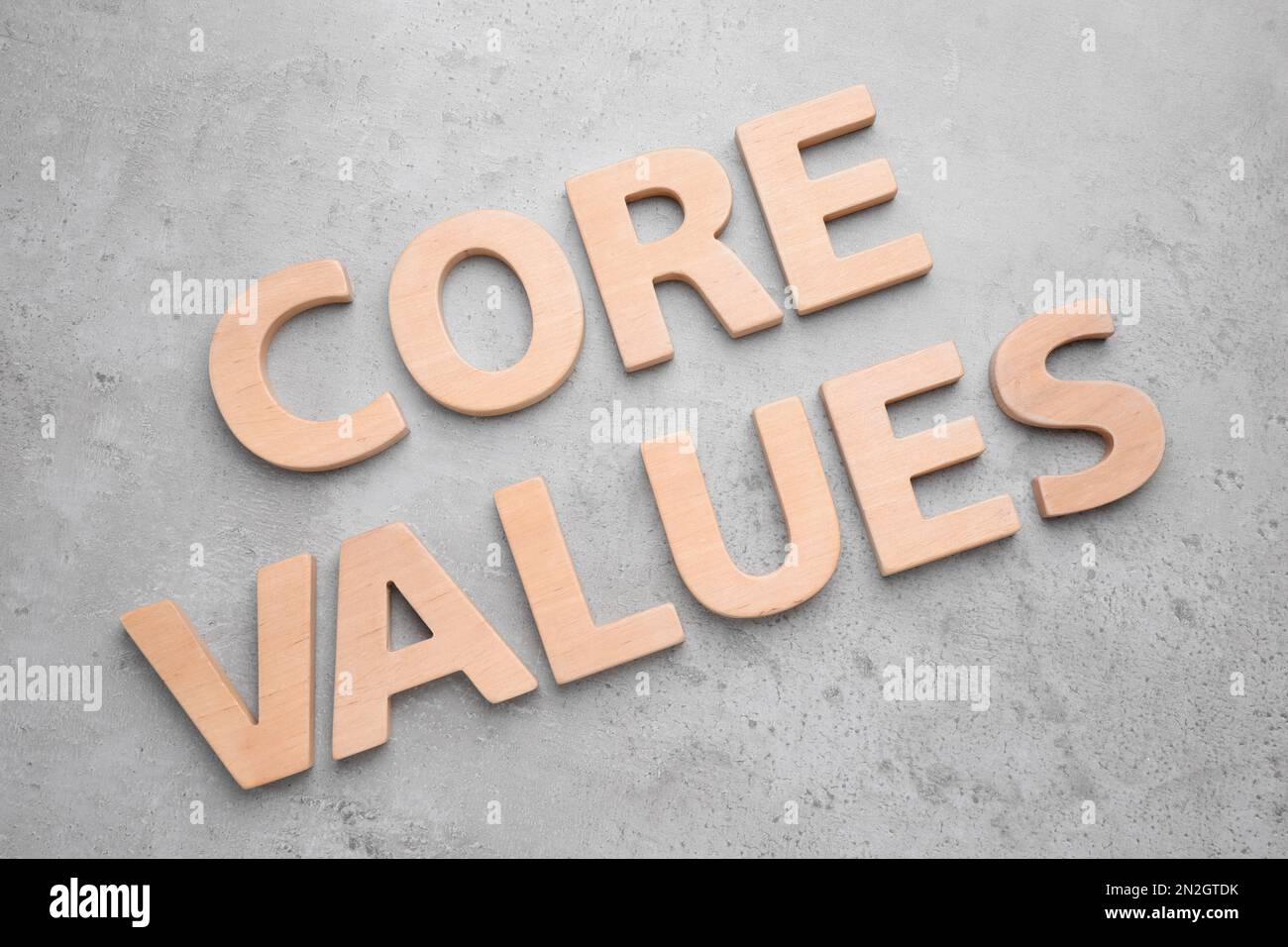 Phrase CORE VALUES made with wooden letters on grey background, flat ...