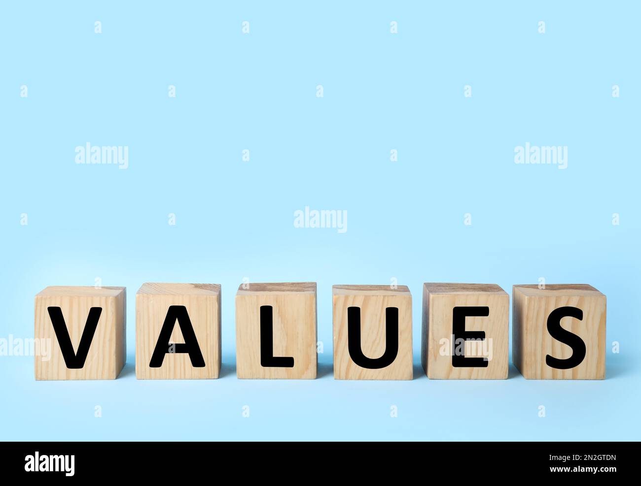 Wooden cubes with word VALUES on light blue background Stock Photo - Alamy