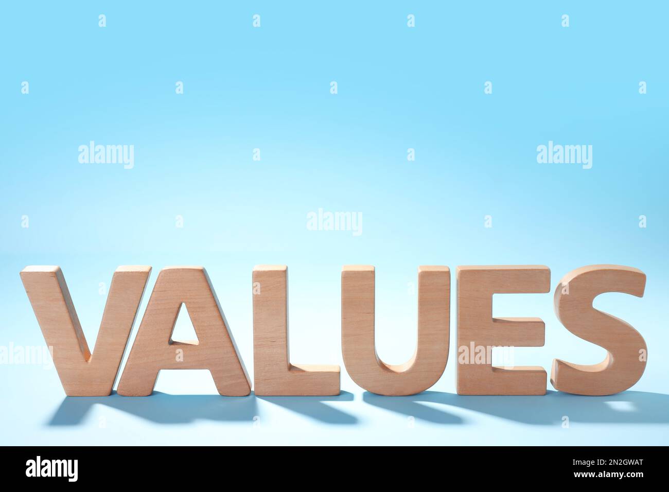 Word VALUES made of wooden letters on light blue background Stock Photo ...