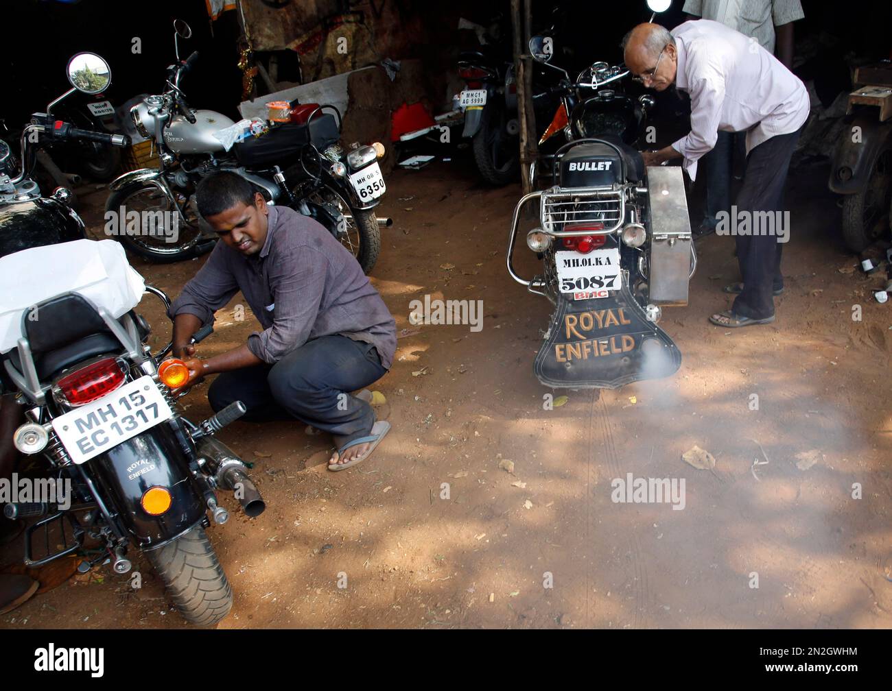 Vehicle fumes come out of a motorbike at a garage in Mumbai, India ...