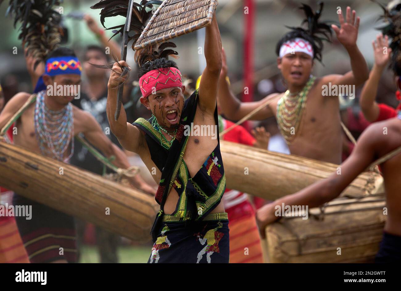 A Garo tribal boy in traditional attire performs the Wangala dance ...