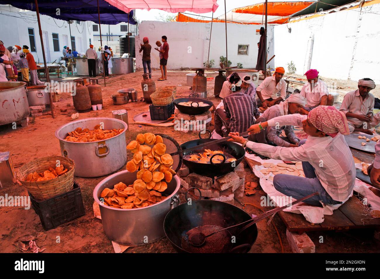 Indian Sikhs prepare food for devotees at a Sikh temple on Baisakhi, in ...