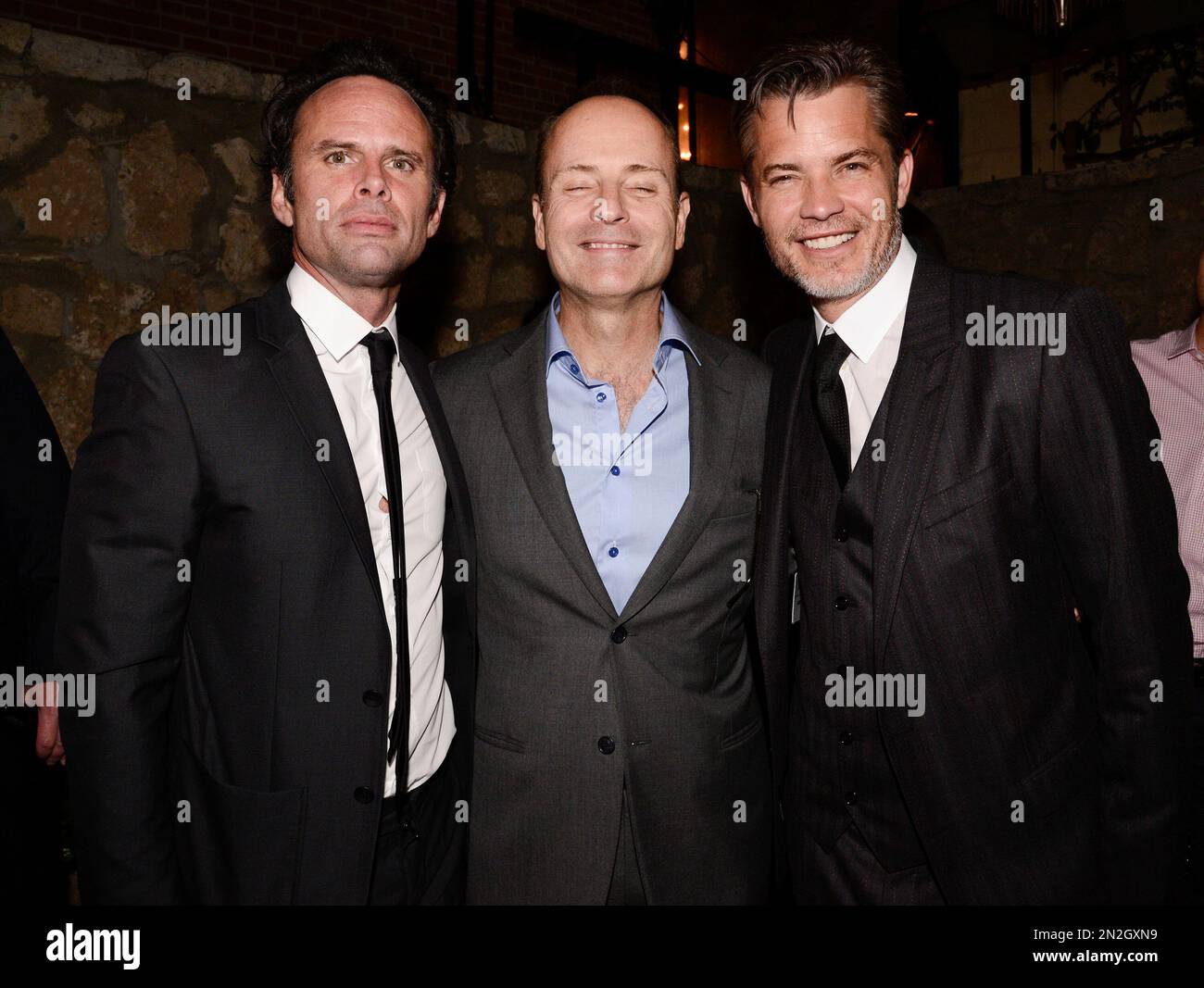 From left to right, actor Walton Goggins, FX Networks CEO John Landgraf ...