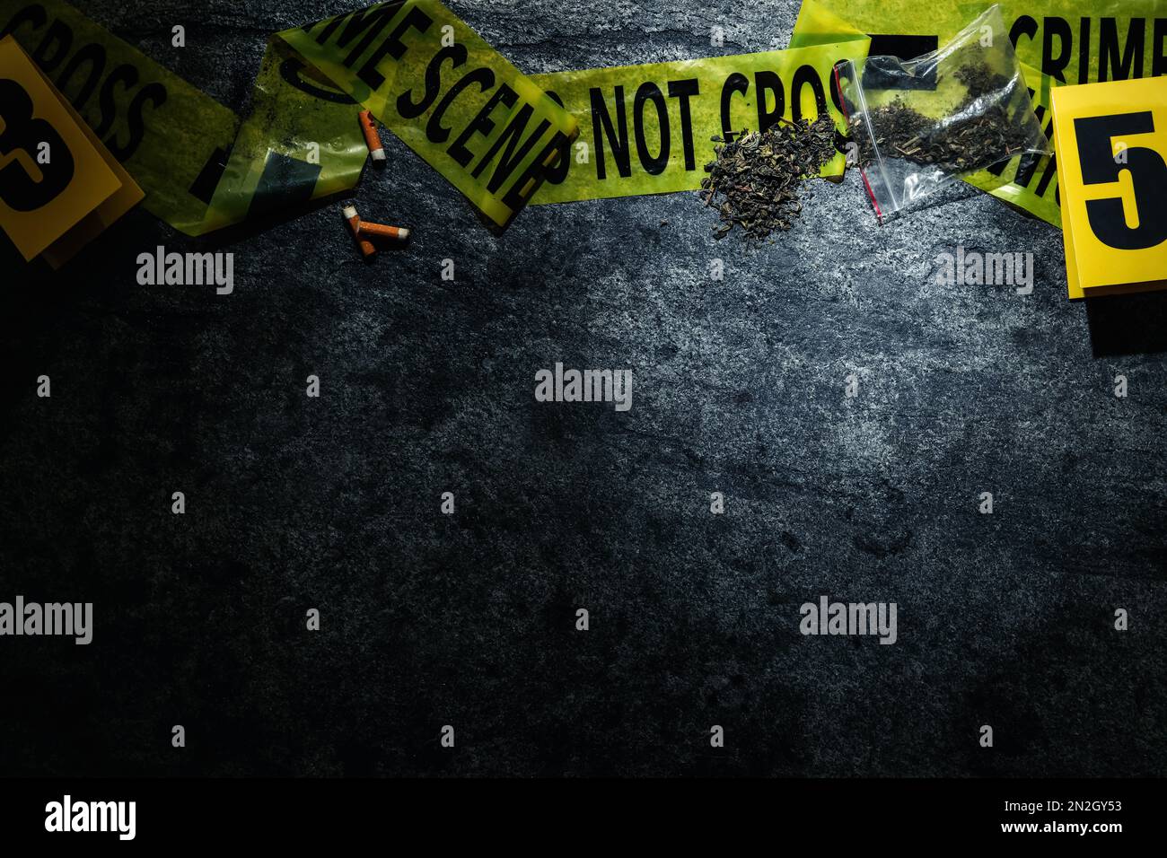 Flat lay composition with evidences and crime scene tape on grey stone ...