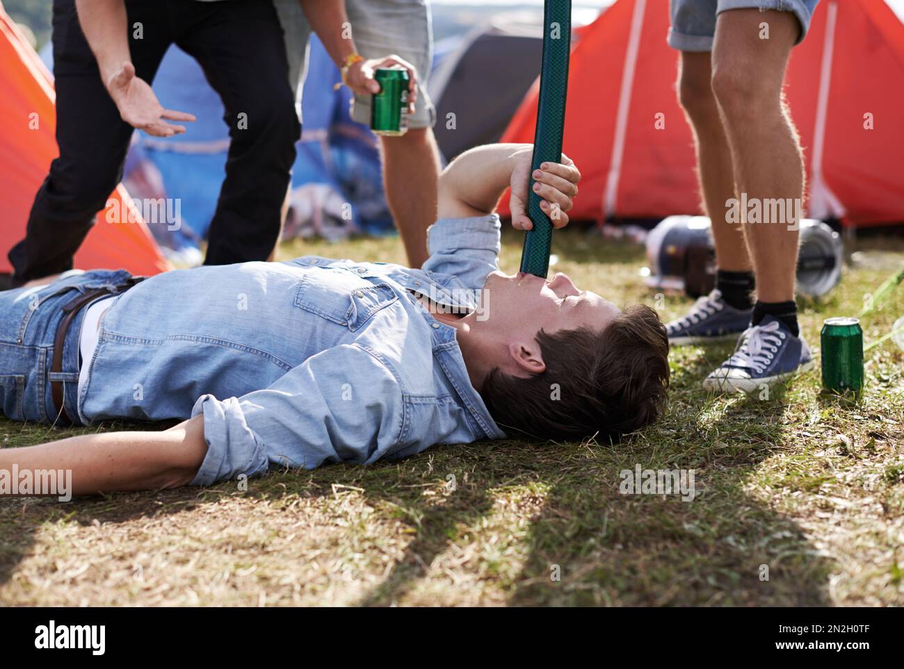 Drink Drink Drink. a man drinking beer at a festival through a funnel ...