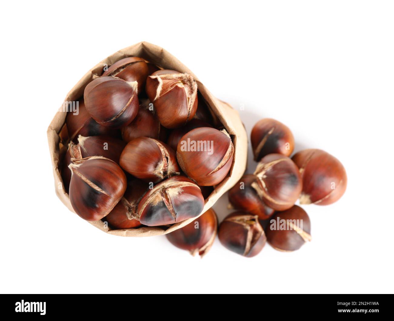 Paper bag with tasty roasted edible chestnuts on white background, top ...