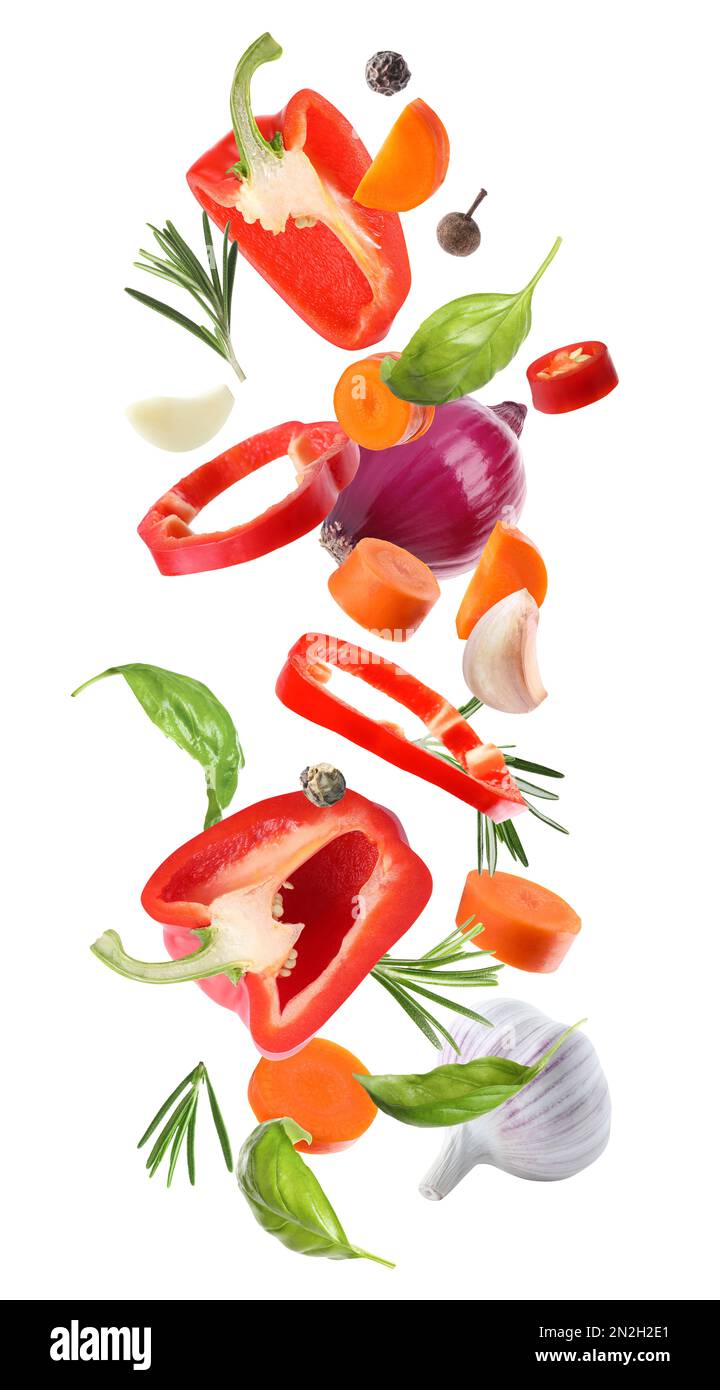 Set of different fresh vegetables and spices falling on white ...