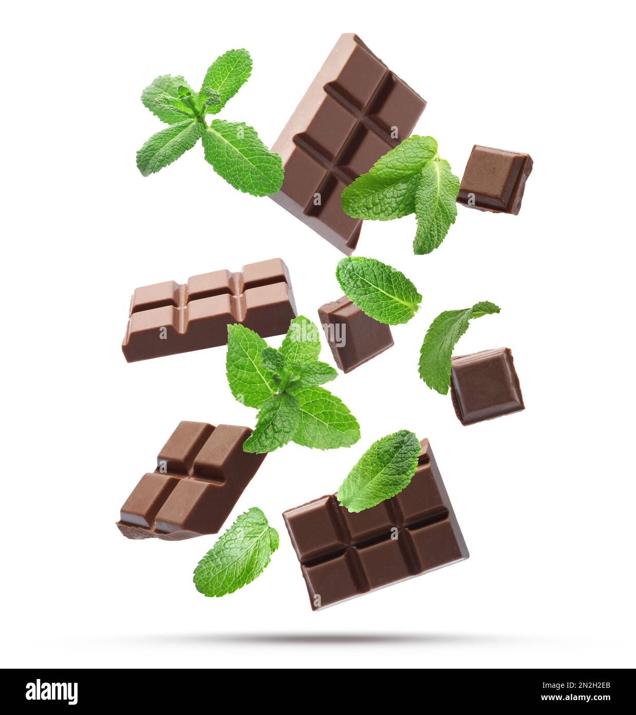 Milk chocolate pieces and mint falling on white background Stock Photo ...