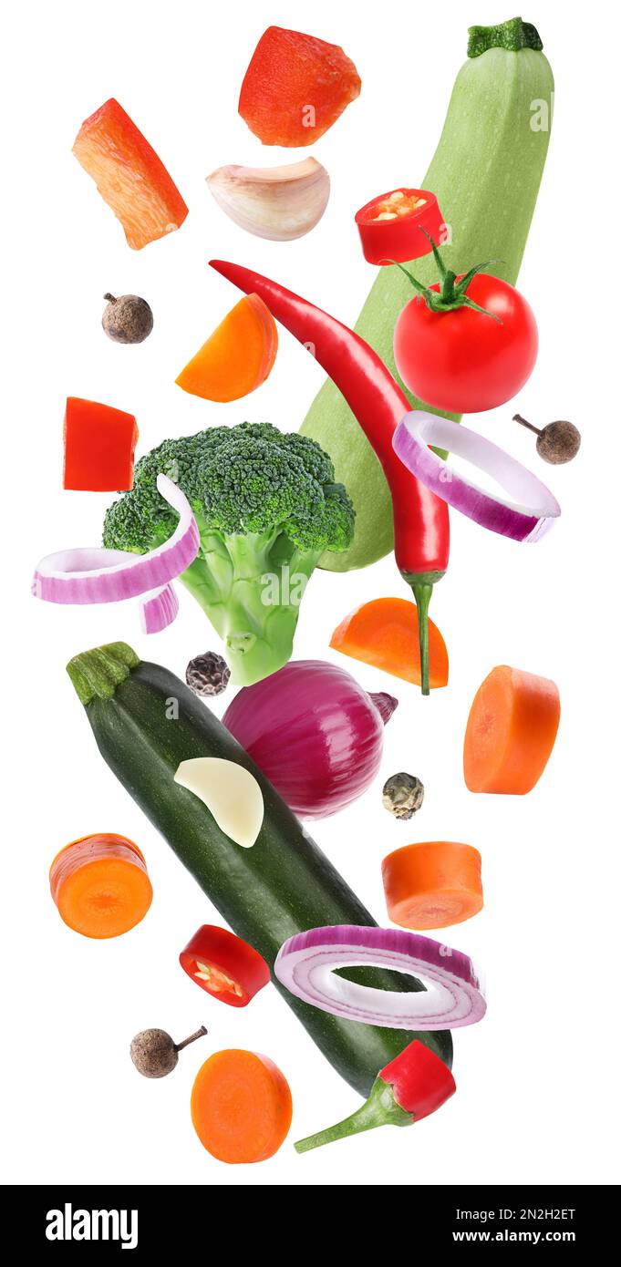 Set of different fresh vegetables and spices falling on white ...