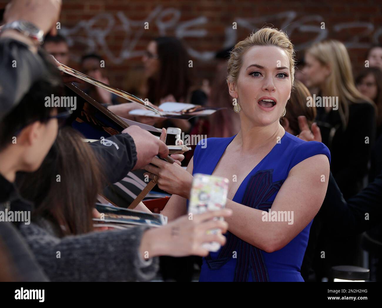 Actress Kate Winslet signs autographs for fans upon her arrival at the ...