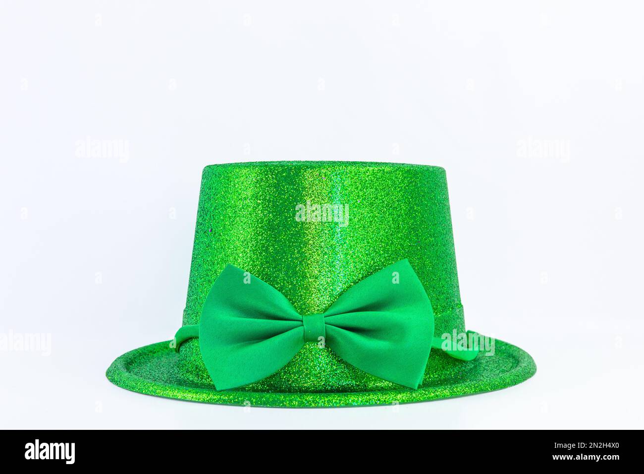 Green Leprechaun hat with glitter and a bow isolated on a white ...