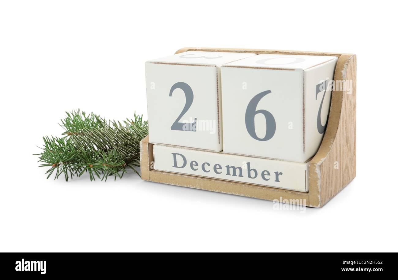 Wooden block calendar with date 26th of December near fir tree branch ...