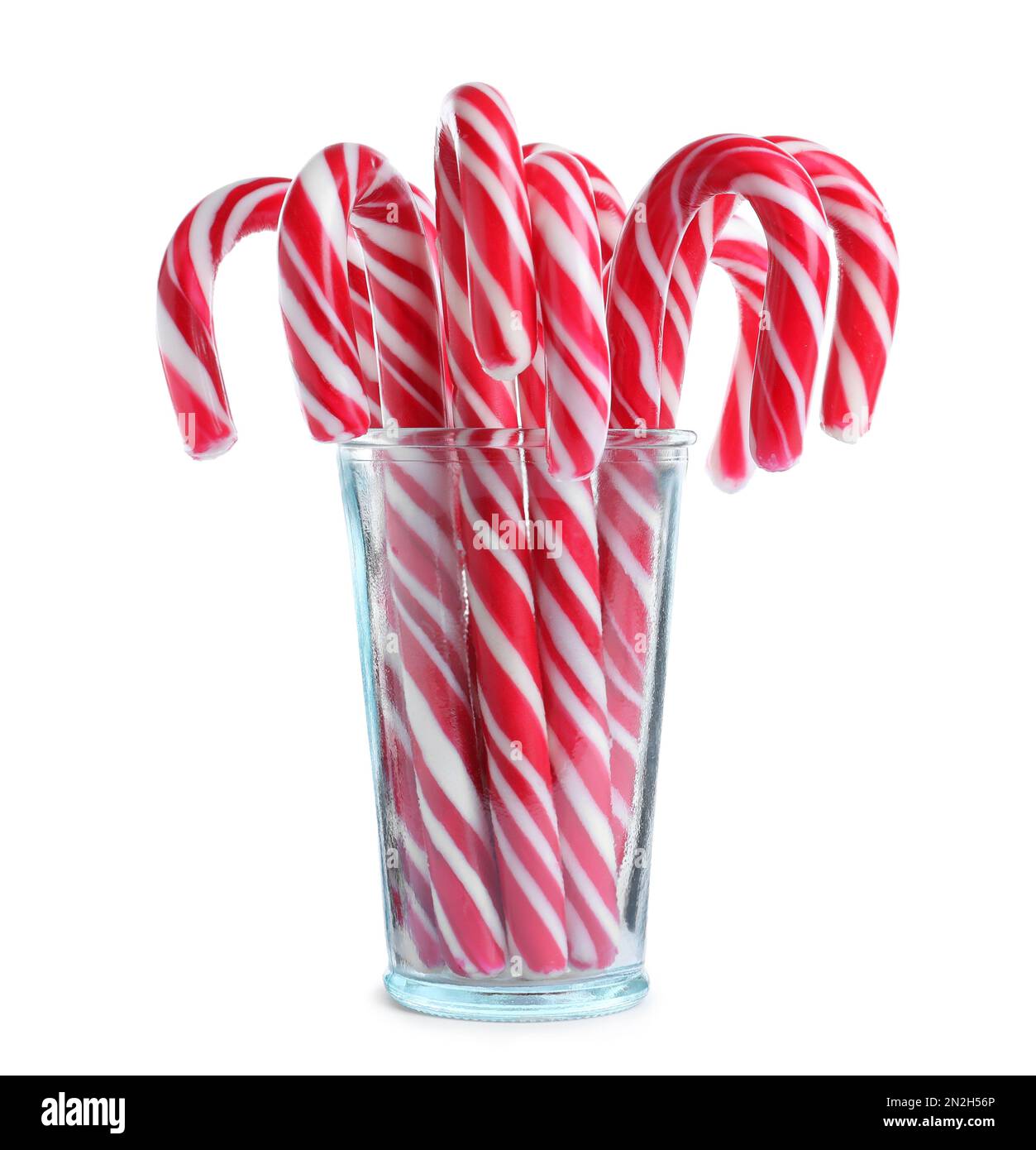 Glass with sweet Christmas candy canes on white background Stock Photo - Alamy