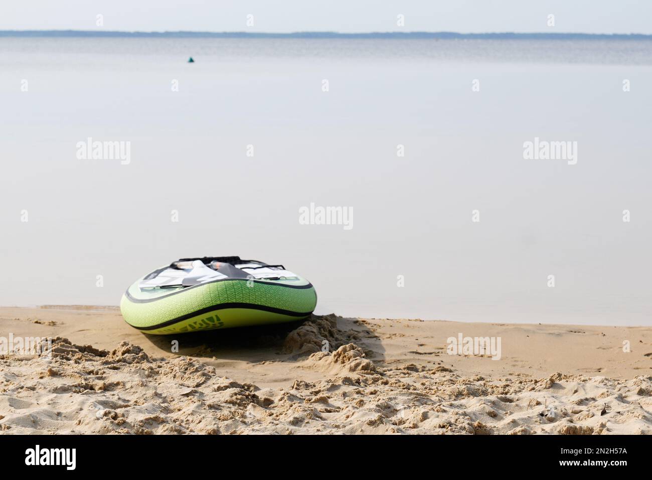 sup paddle board lying on sand near beach lake water on the lakeside ...