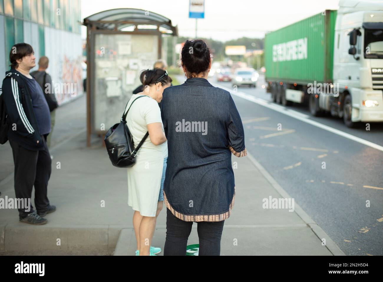 People are waiting for bus. Waiting for transport at bus stop. People ...