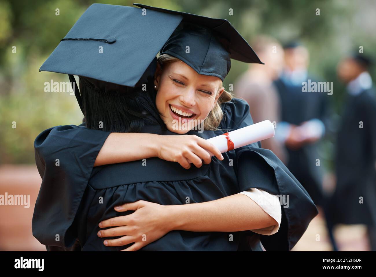 Weve finally graduated. Two college graduates hugging one another in ...
