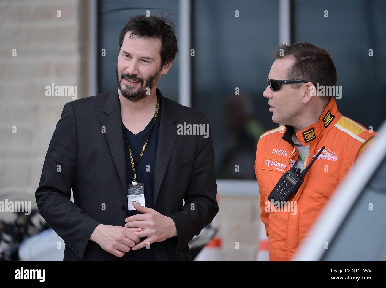 Actor Keanu Reeves, left, talks with track doctor James Kempeme, right ...