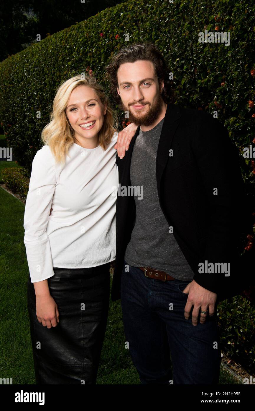 Elizabeth Olsen, left, and Aaron Taylor-Johnson pose during a portrait ...