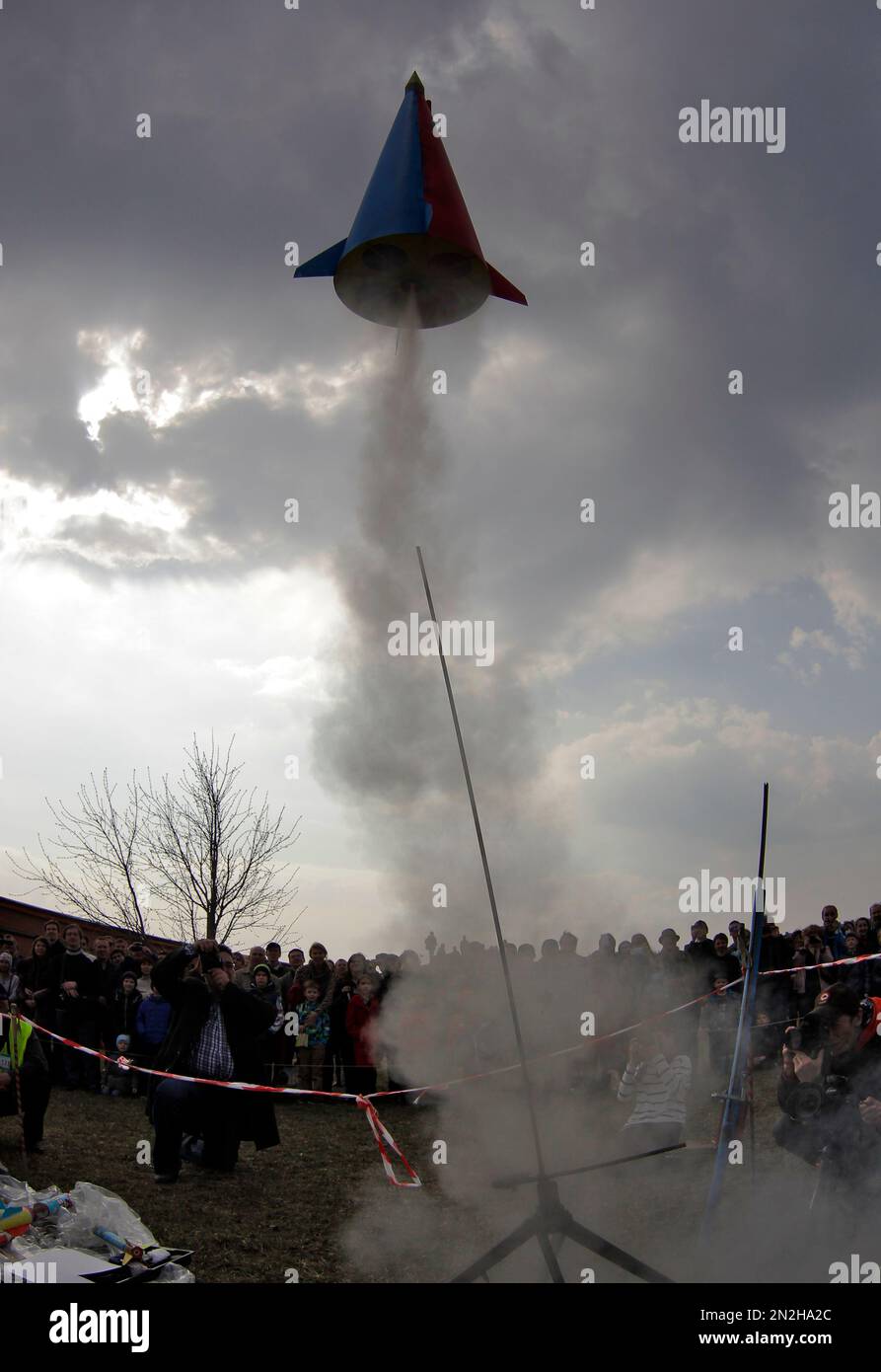 People watch the launch of a model rocket during a celebration of the ...