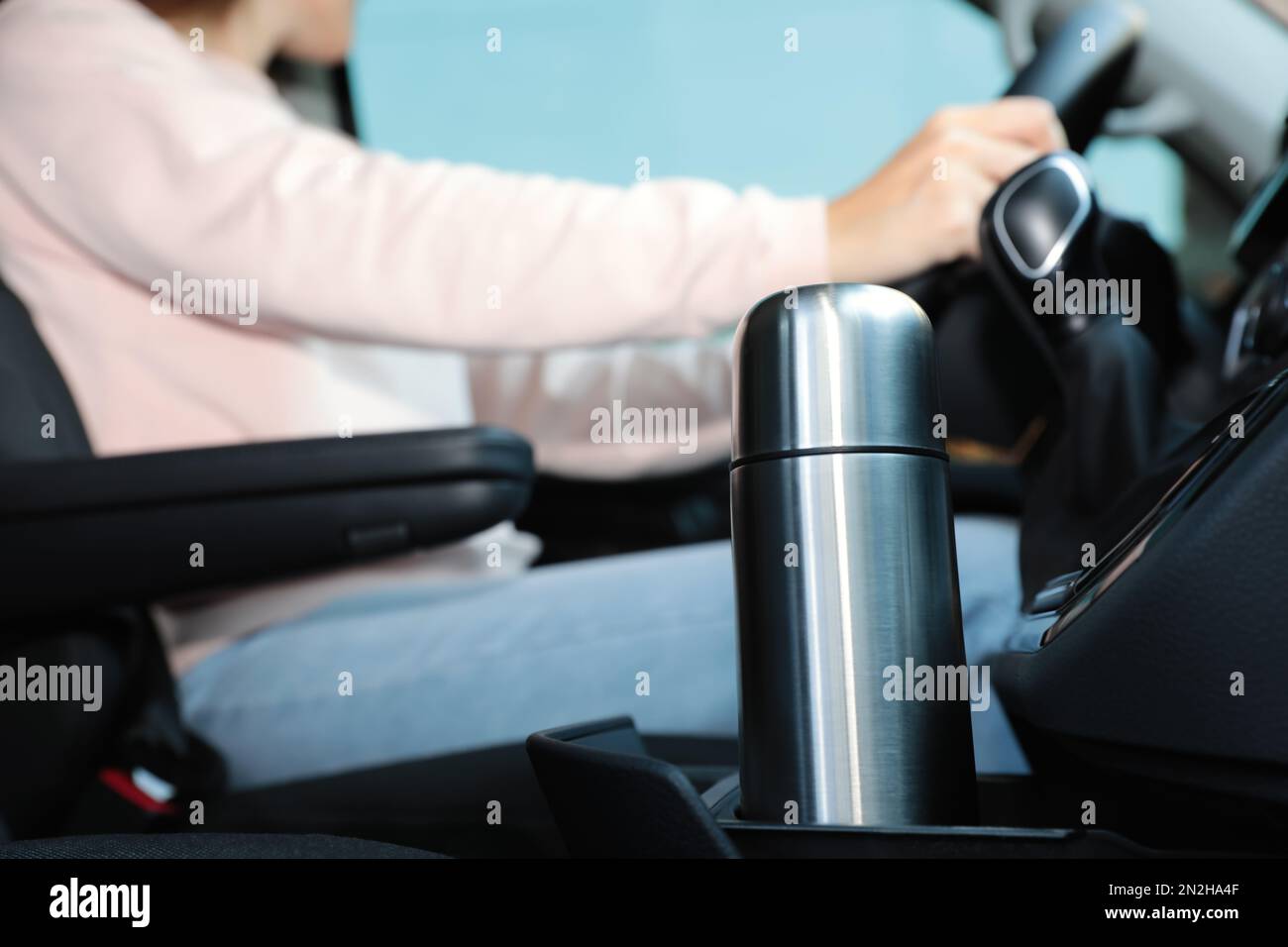 Silver thermos in holder inside of car Stock Photo - Alamy