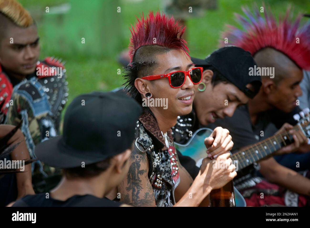 Myanmar youngsters in punk fashion sing a song as they gather at a park ...