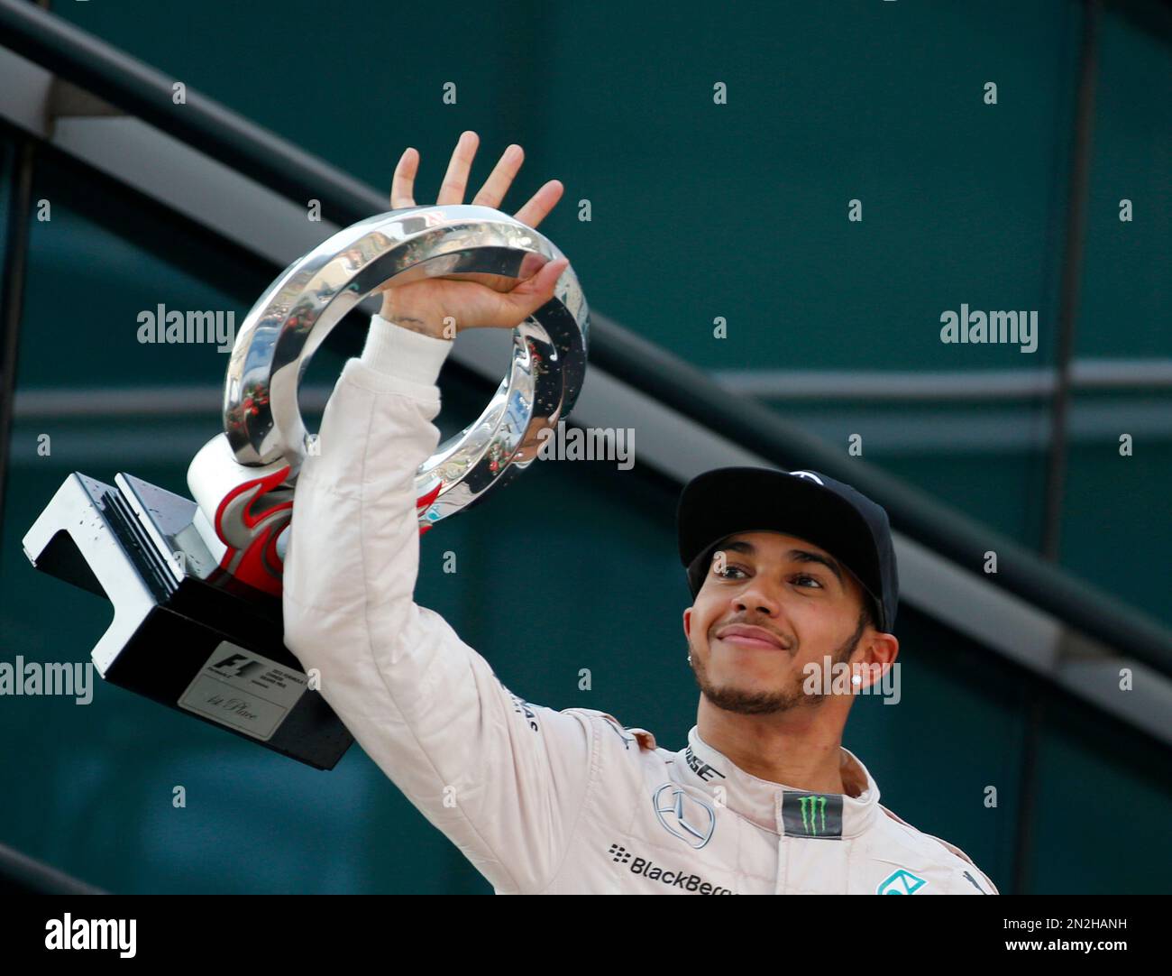 Mercedes driver Lewis Hamilton of Britain waves with his trophy on the ...