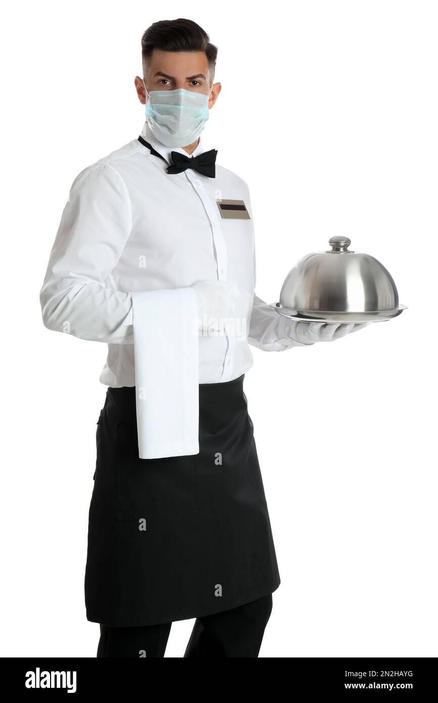 Waiter in medical face mask holding tray with lid on white background ...