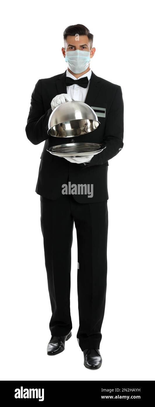Waiter in medical face mask holding tray with lid on white background ...