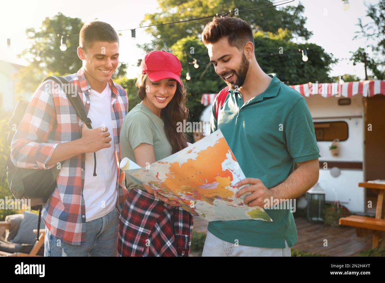 Young travelers with backpacks and map planning trip outdoors Stock Photo - Alamy