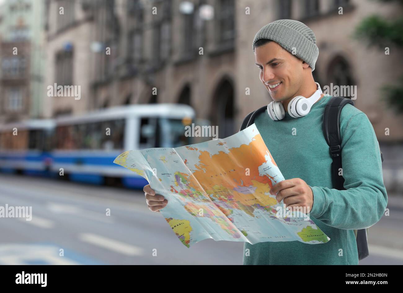 Happy traveler with map in foreign city. Vacation trip Stock Photo - Alamy